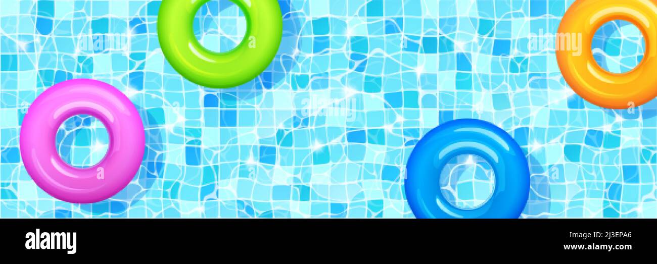 Swimming pool with colorful inflatable rings floating on clean water ...