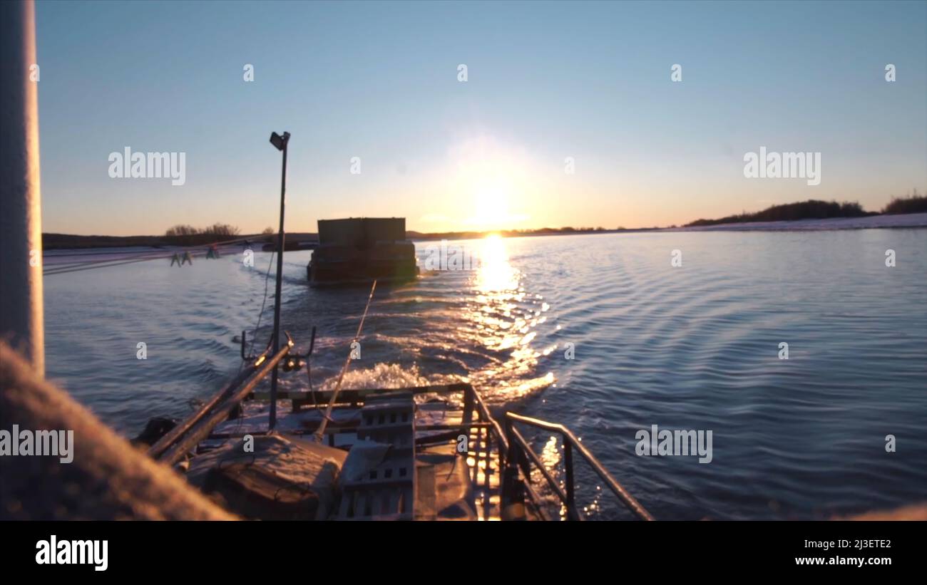 View of floating barge behind ship. Clip. Trading barge floats on river ...
