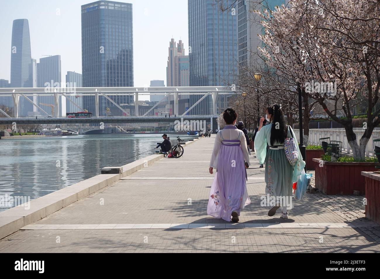 Young girls wear traditional Han costume walking on the city street ...