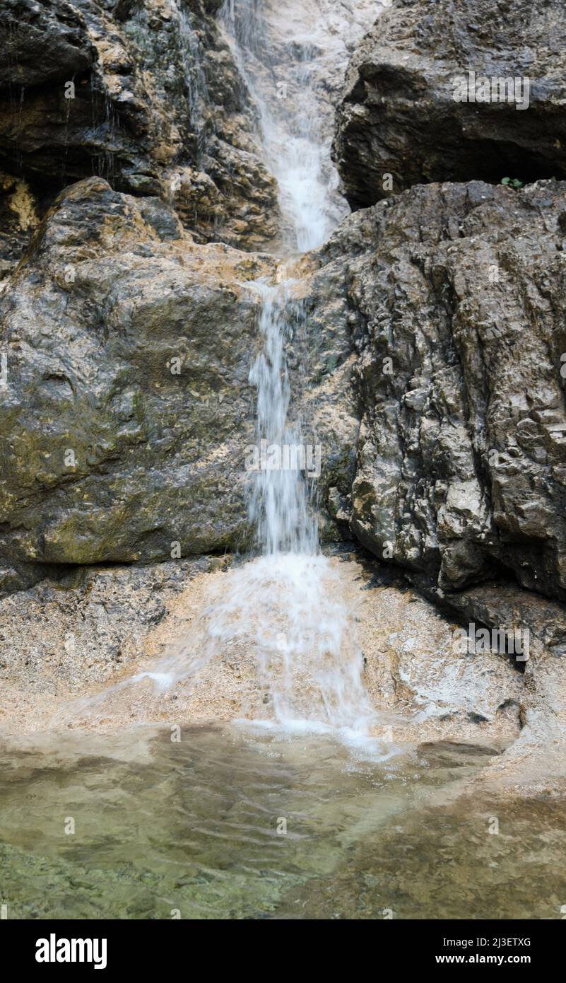 clear spring water that flows from the rock forming a waterfall Stock ...