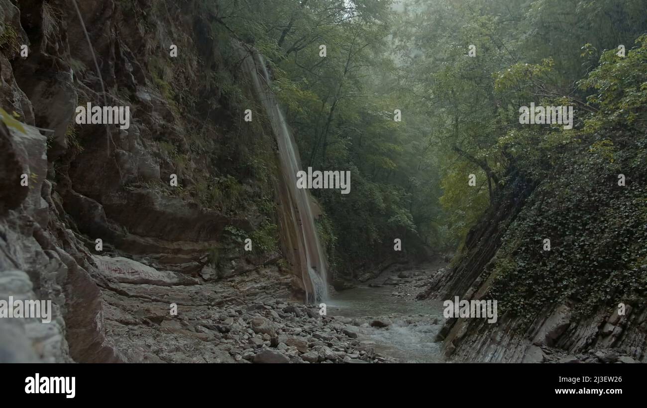 Beautiful waterfall on rock in jungle. Creative. High narrow waterfall ...