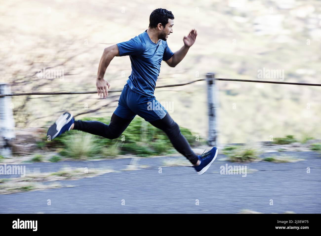 Some serious speed. Full length shot of a handsome young male athlete ...