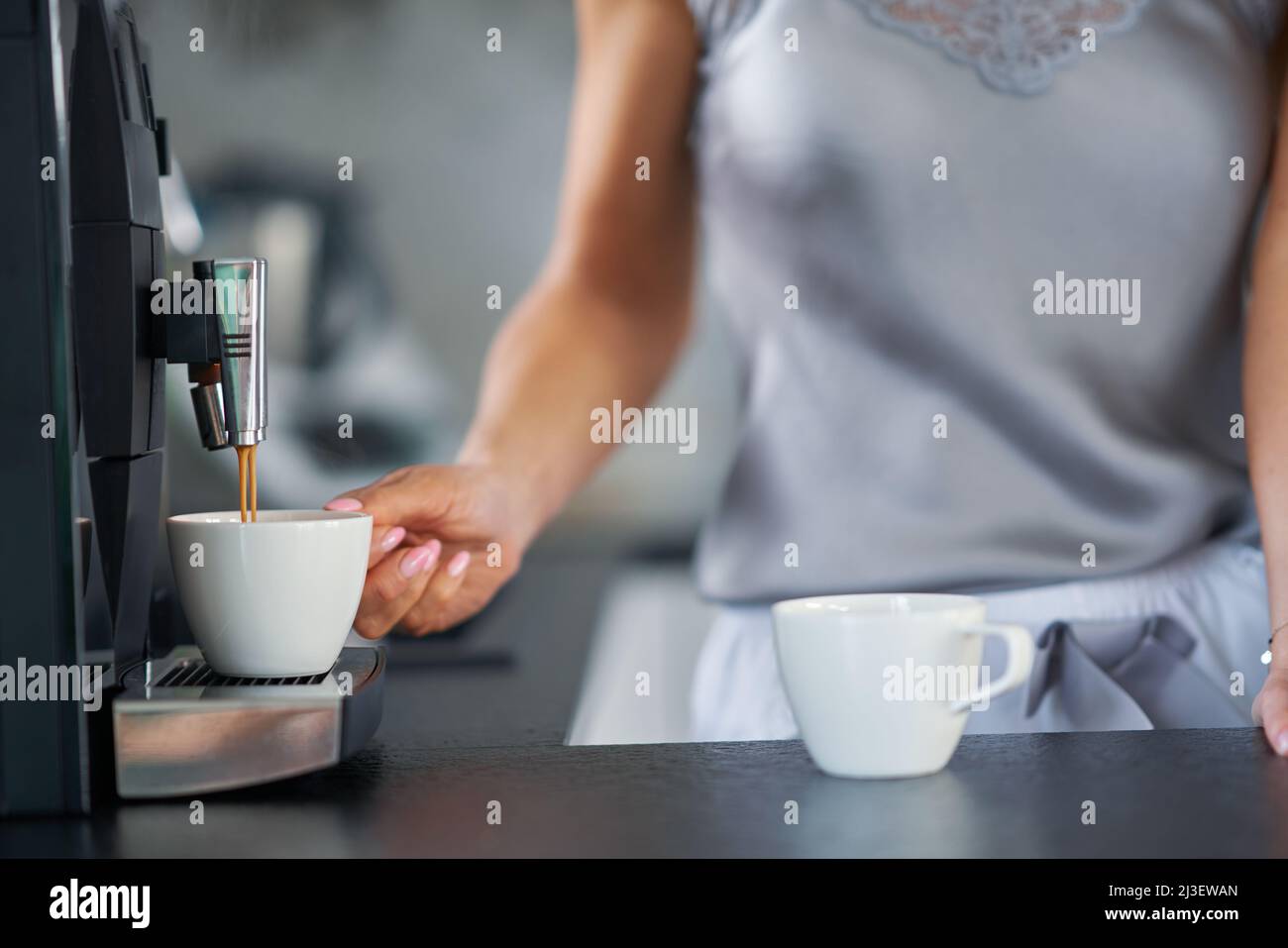 Nice woman making coffee in the kitchen Stock Photo - Alamy