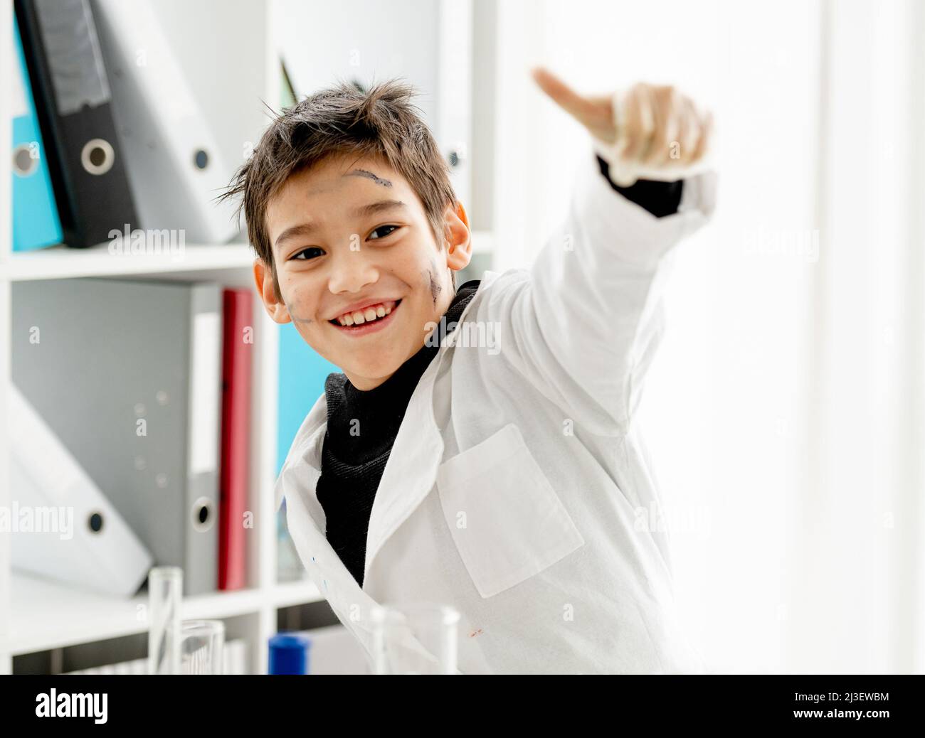 School boy showing super with hands holding big fingers up during ...