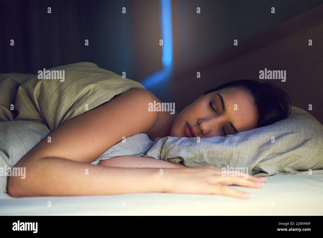 Getting a good nights sleep. Shot of a young woman sound asleep in her ...