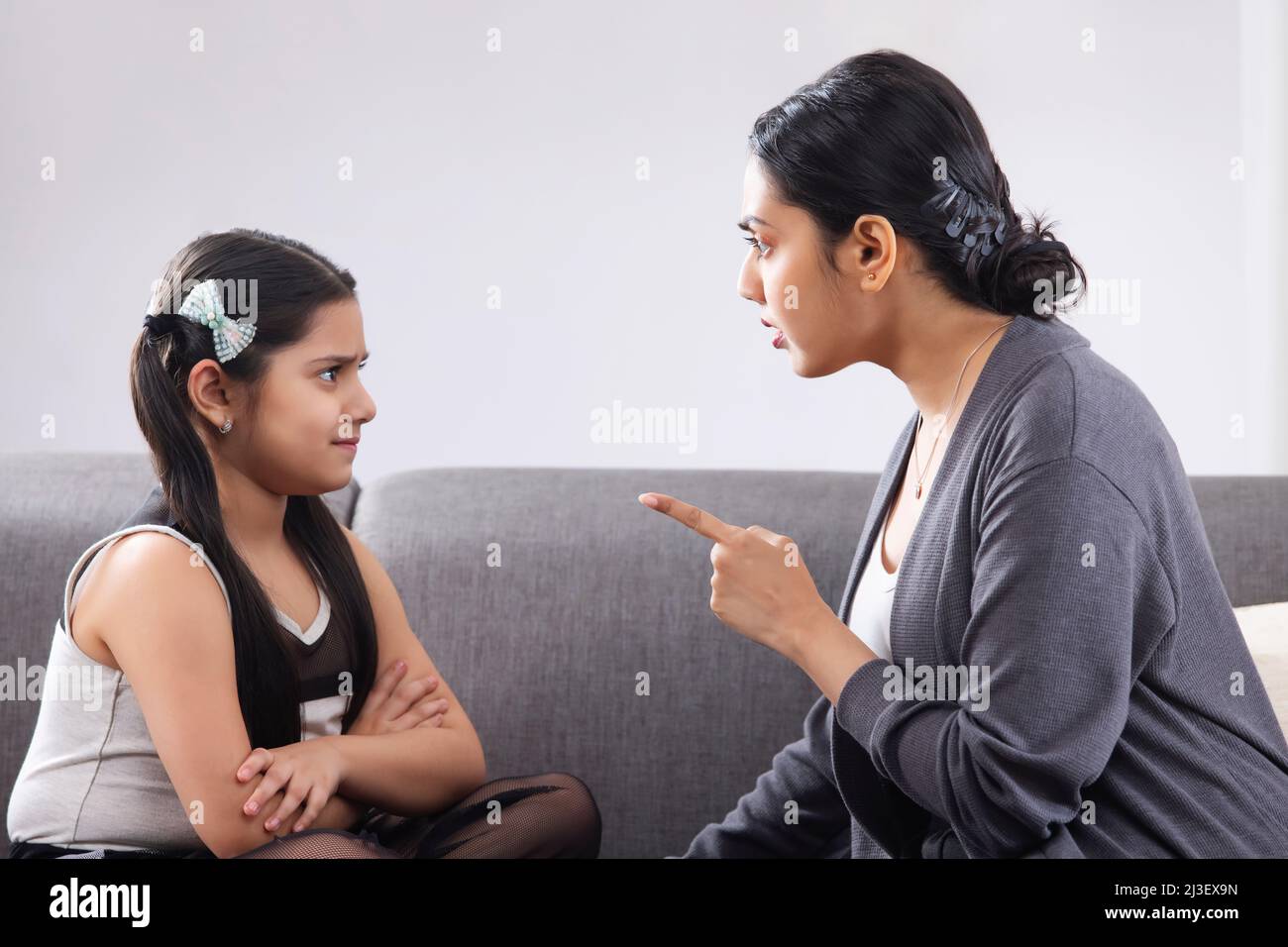 Mother scolding her daughter by showing finger at home Stock Photo - Alamy