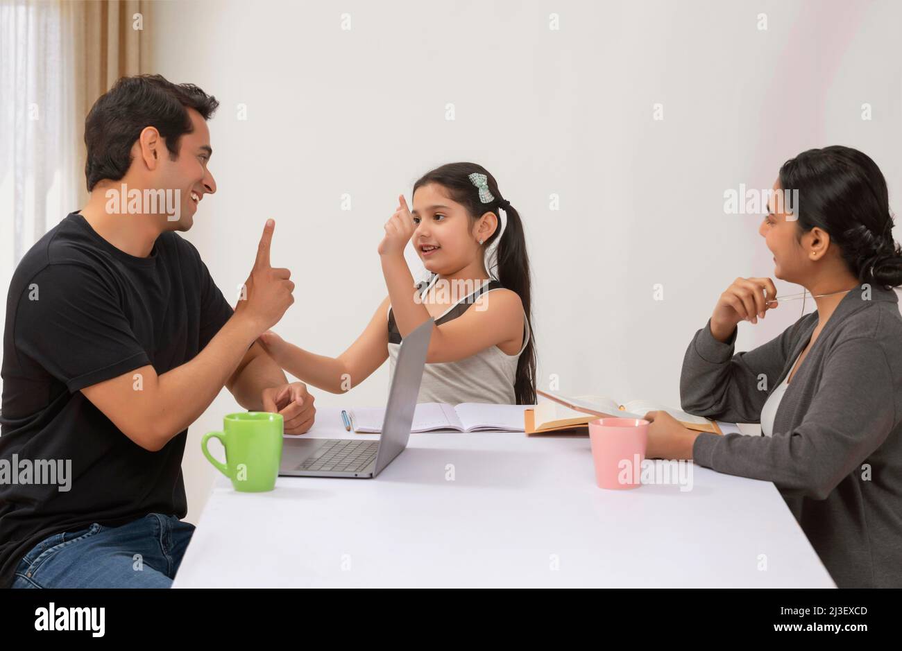 Parent helping their daughter with homework Stock Photo - Alamy