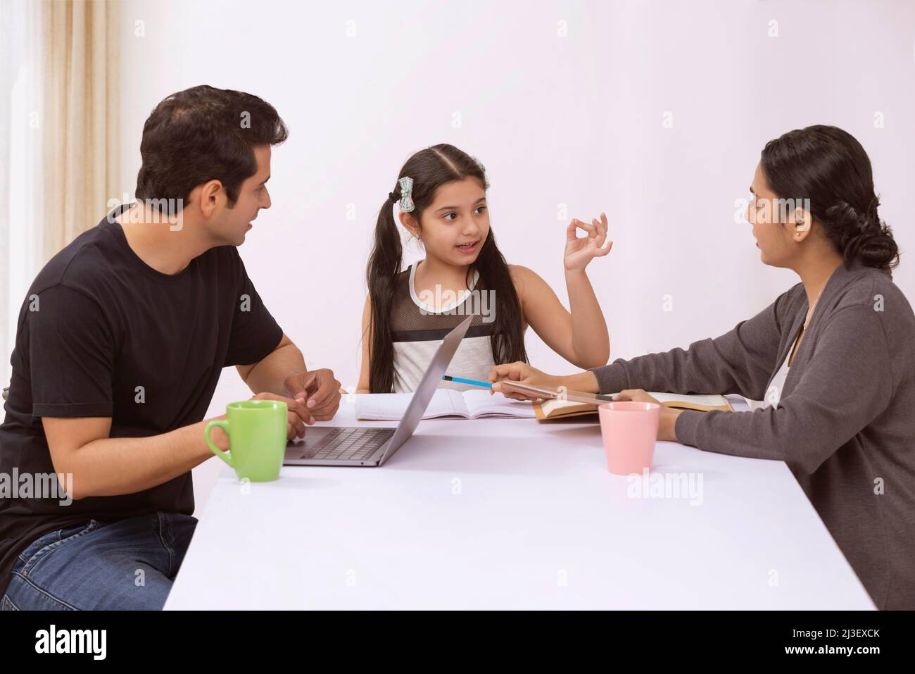Parent helping their daughter with homework Stock Photo - Alamy