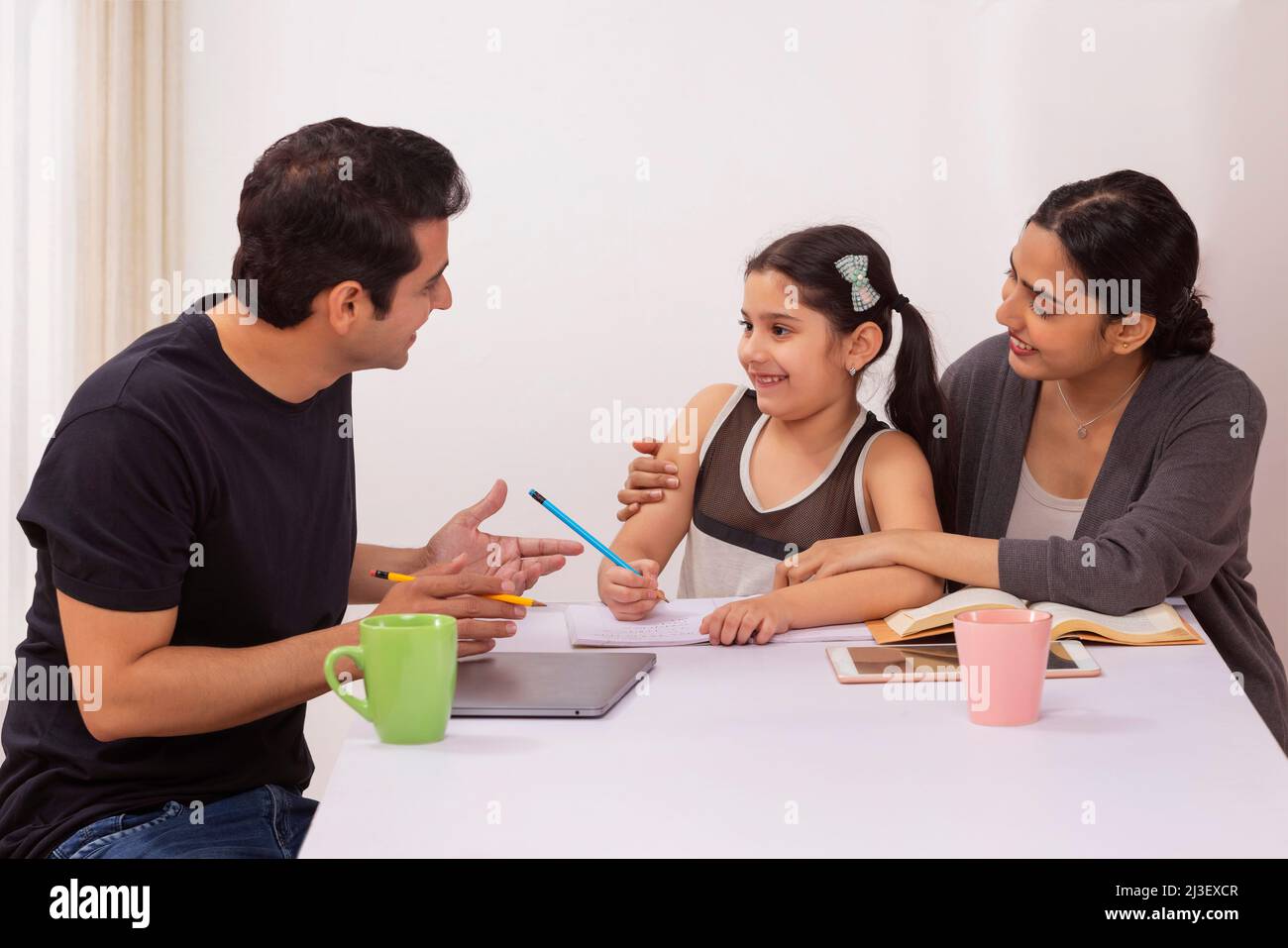 Parent helping their daughter with homework Stock Photo - Alamy