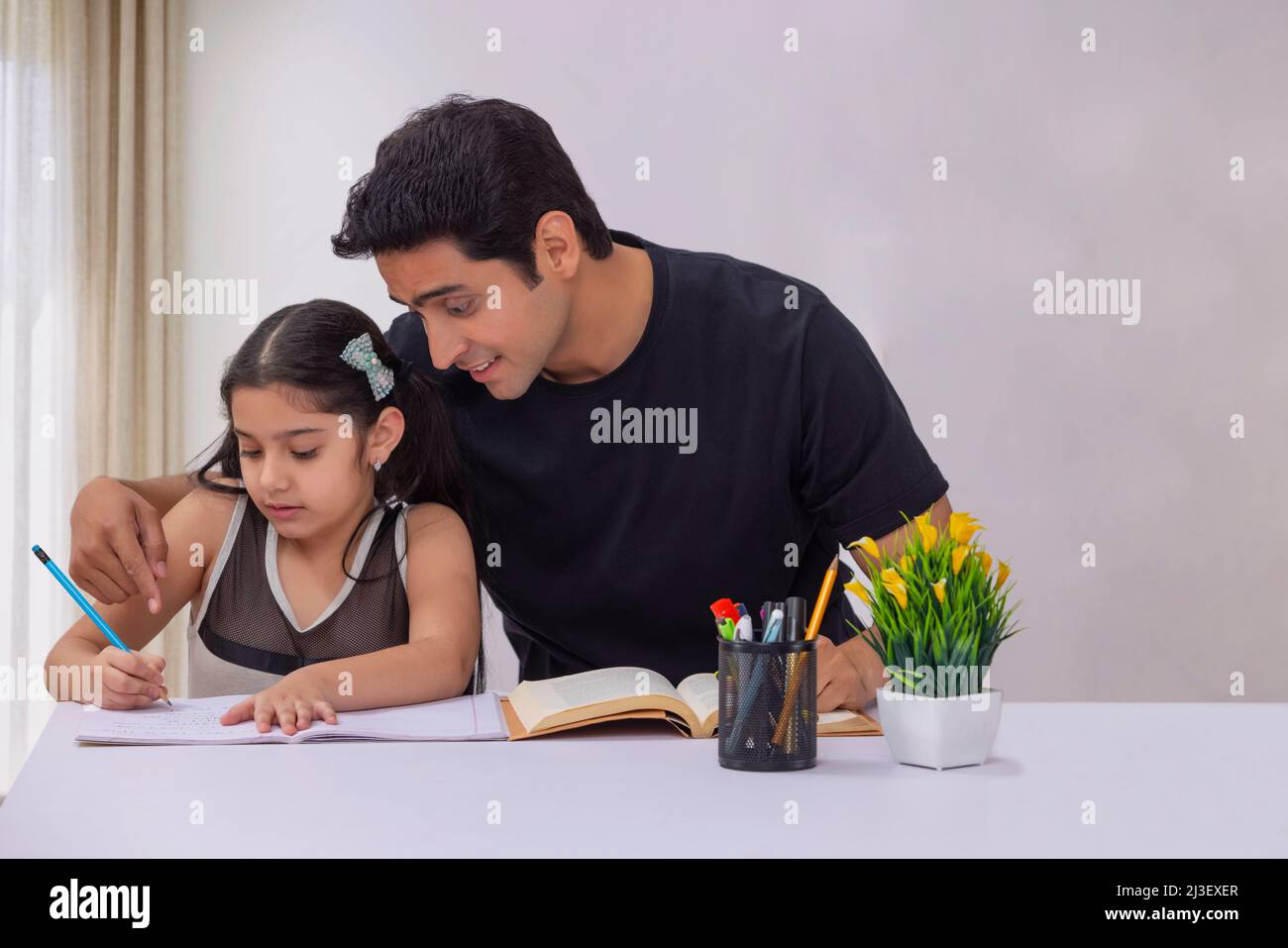 Father helping his daughter with homework Stock Photo - Alamy