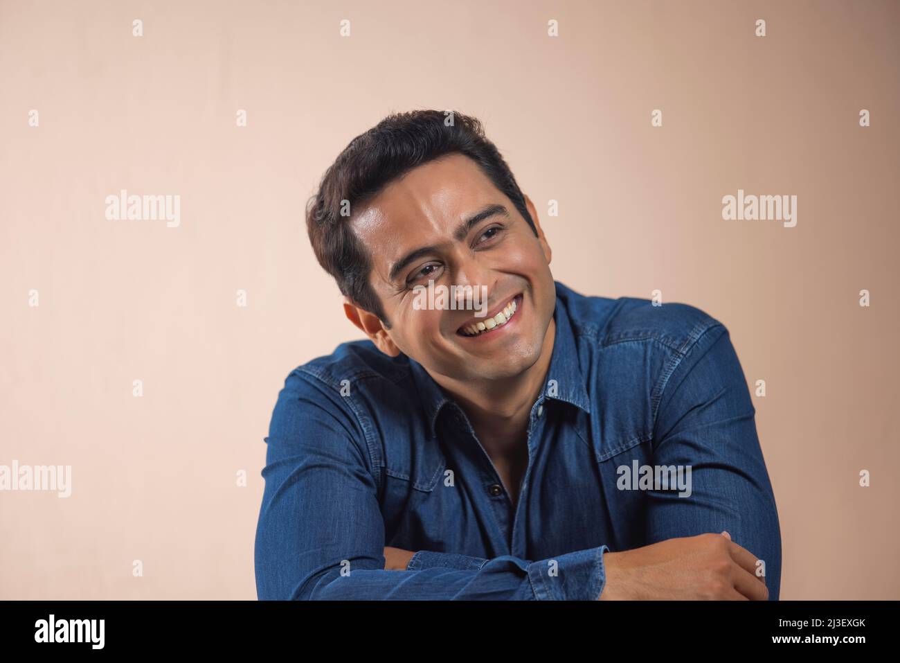 Portrait of happy young man looking elsewhere with smile Stock Photo ...