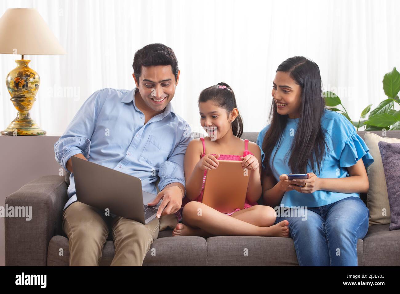Family using laptop tablet smartphone hi-res stock photography and ...