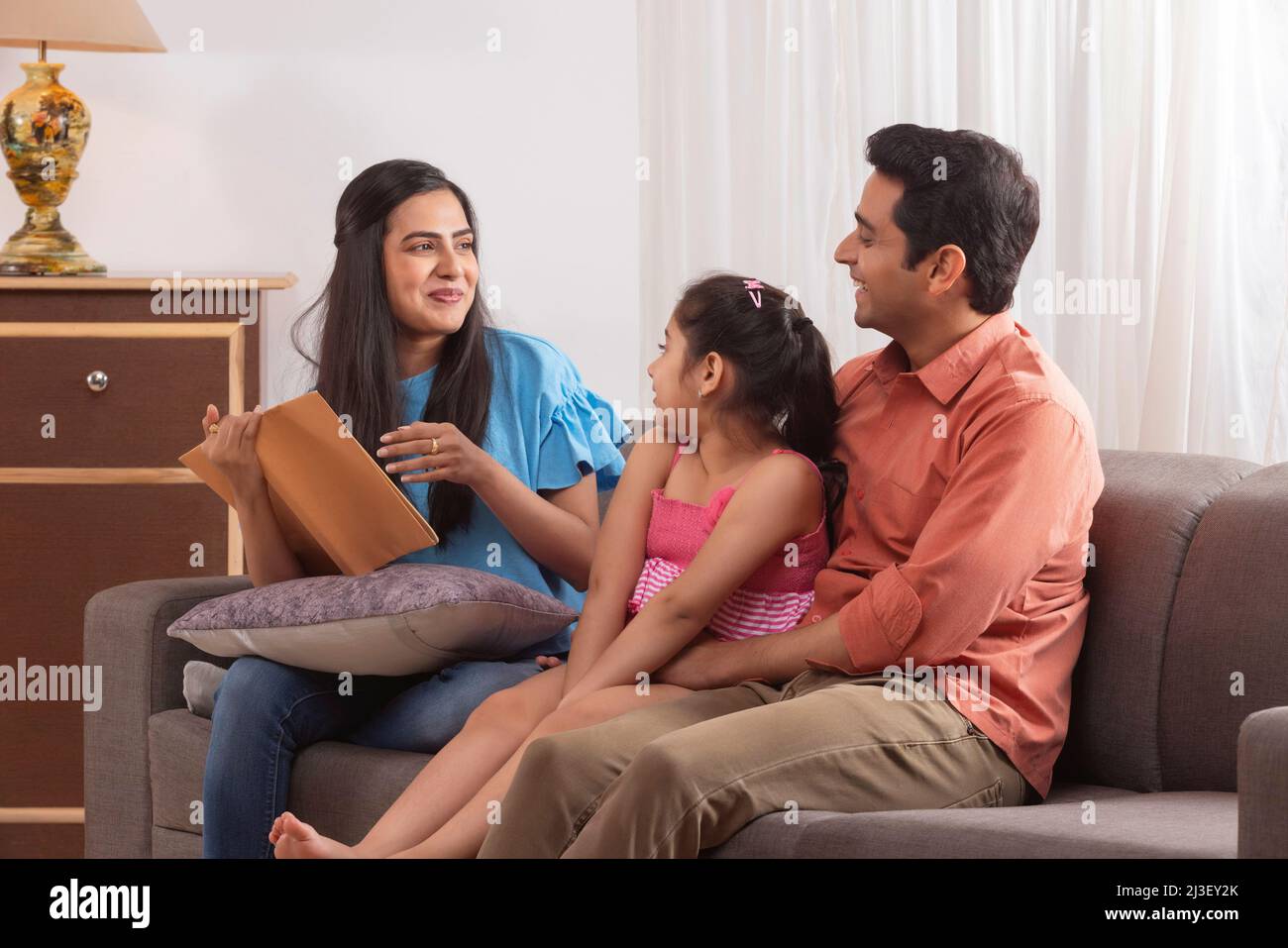 Father mother child talking sofa hi-res stock photography and images ...