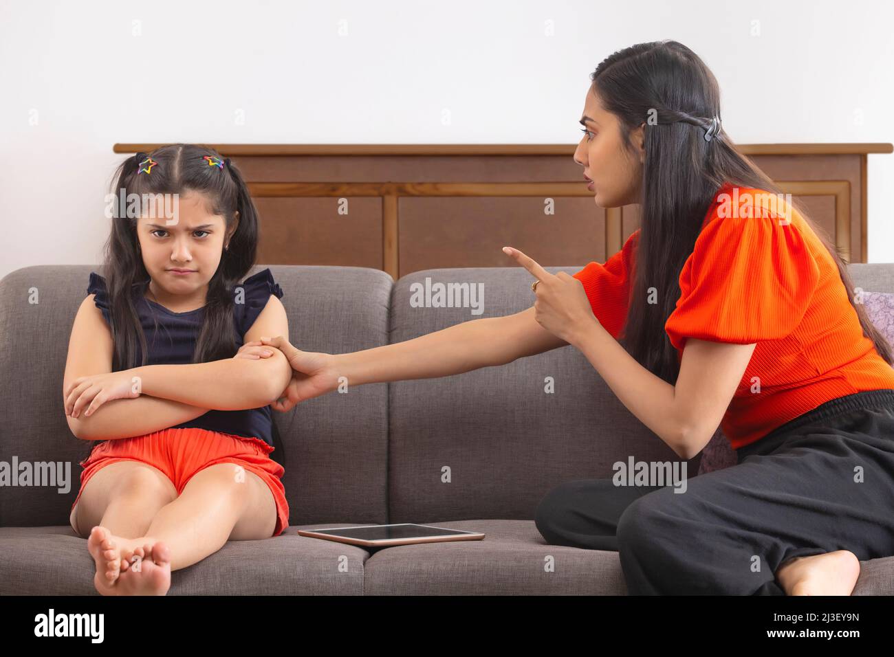 Mother scolding her daughter by showing finger at home Stock Photo - Alamy