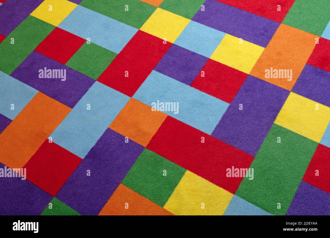 Bright colorful carpet on the floor, used and slightly dirty Stock ...