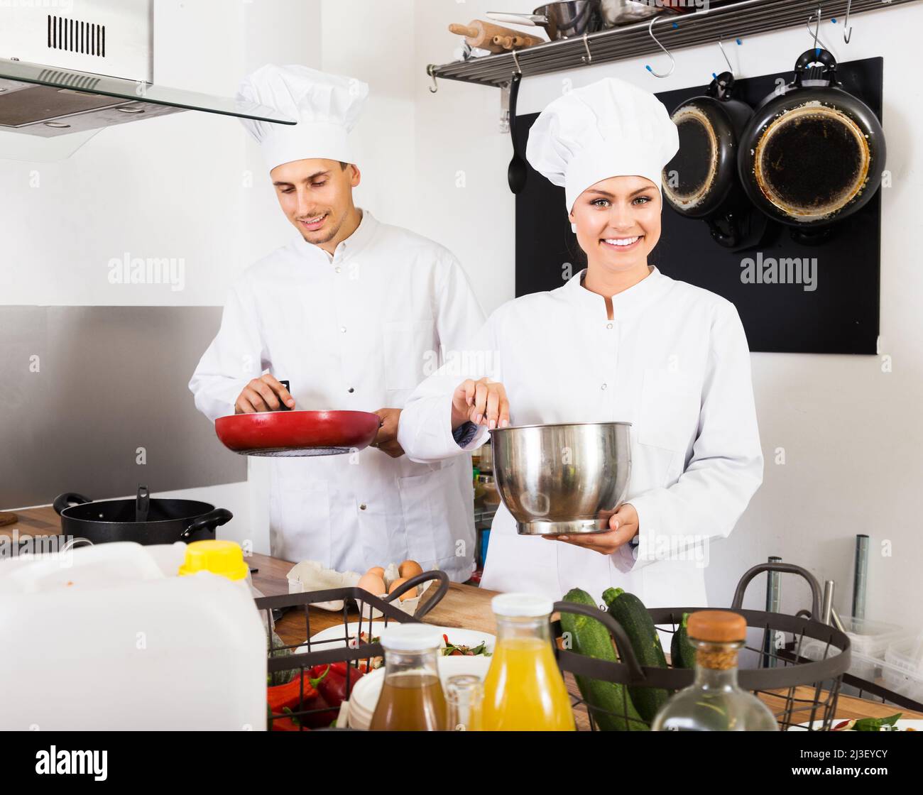Two chefs cooking food Stock Photo - Alamy