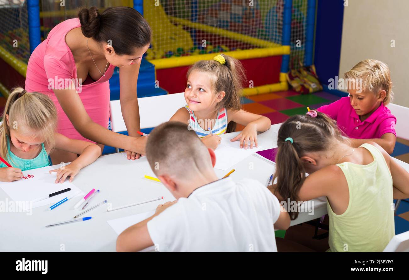 children sitting together and drawing in class at school Stock Photo ...