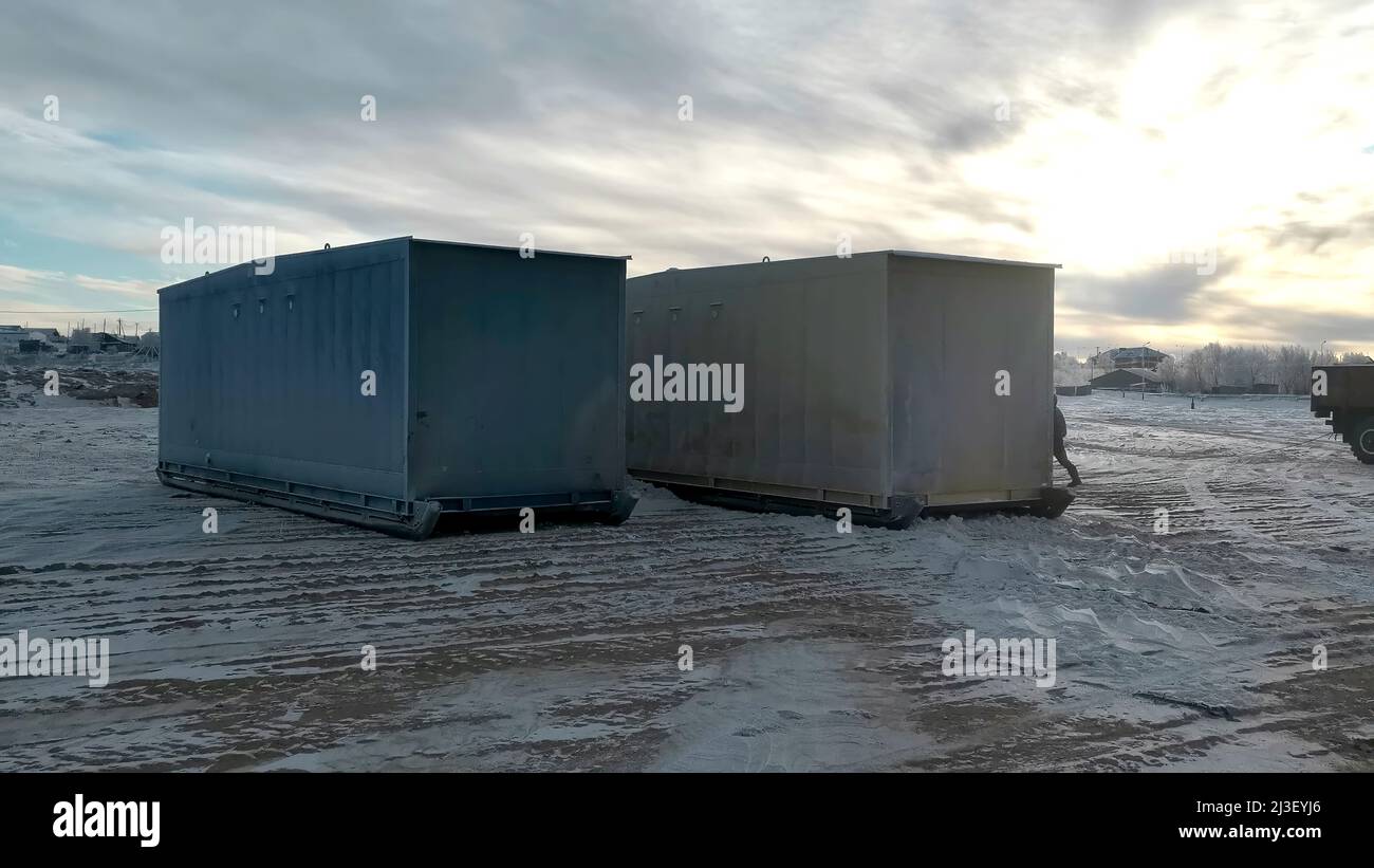 Unloading cargo containers in winter. Clip. Large containers are ...