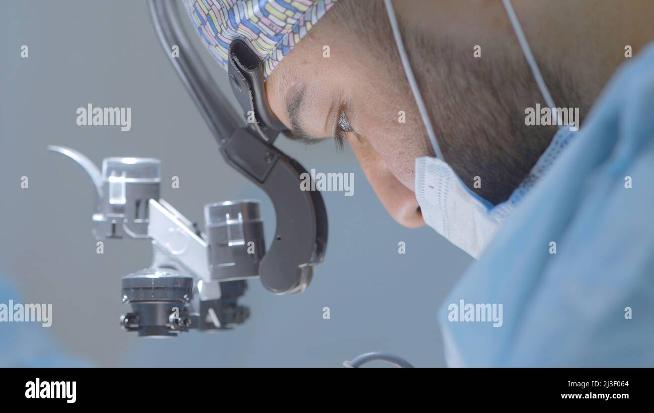 Close-up of surgeon performing operation. Action. Focused and serious ...