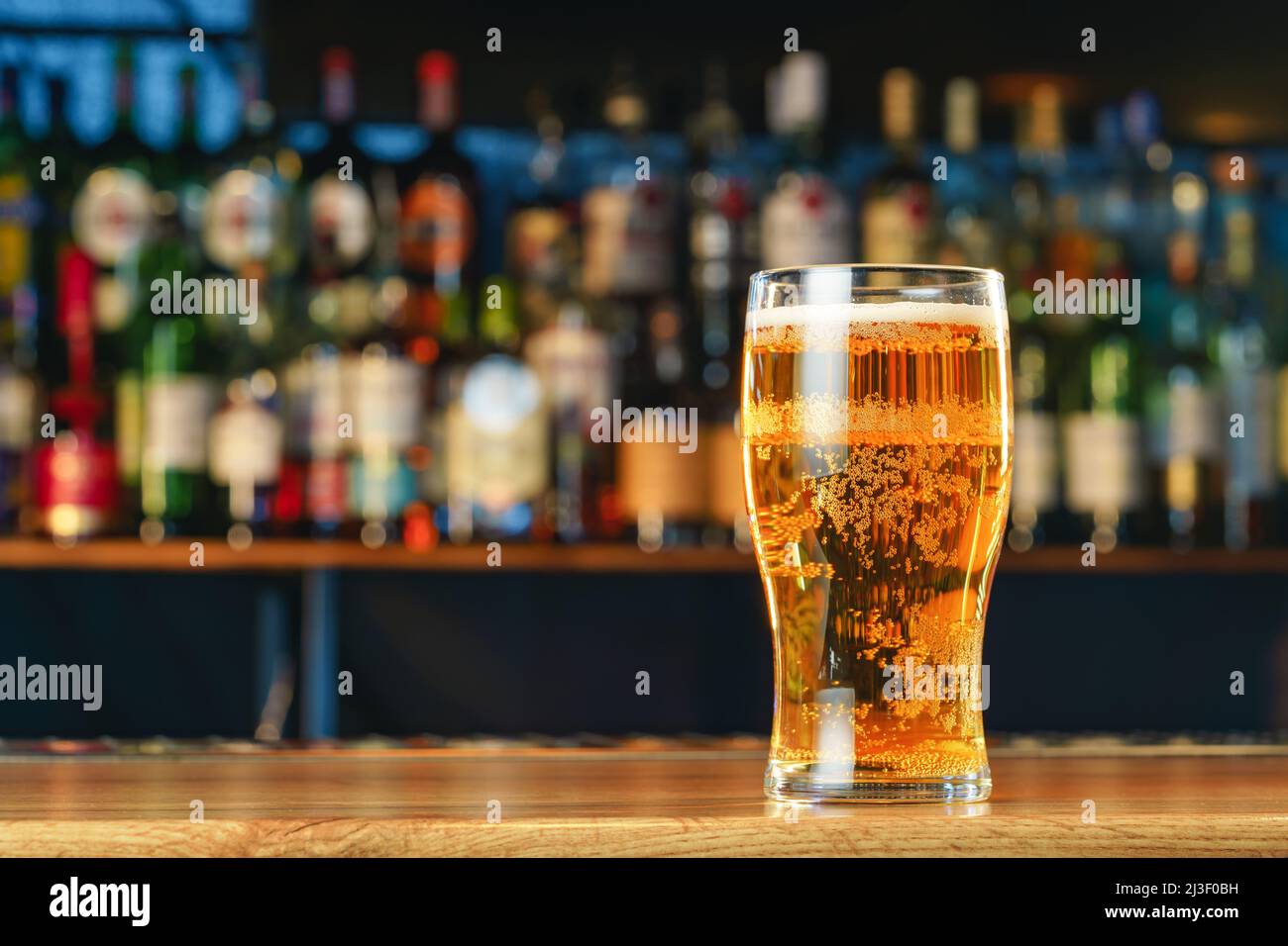 Fresh cold beer in glass on bar background Stock Photo - Alamy