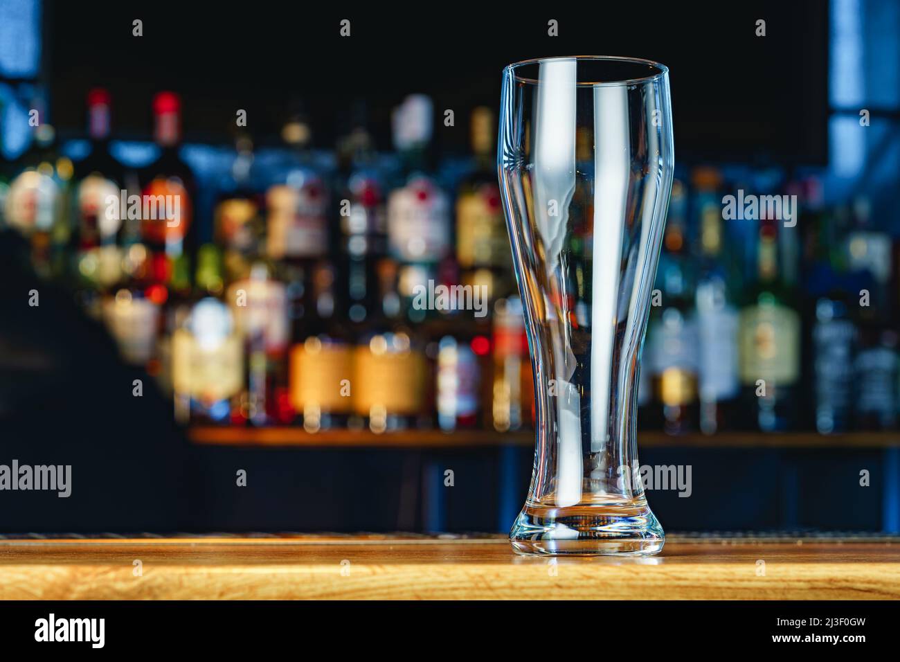 Empty beer glass on a wooden bar counter Stock Photo - Alamy
