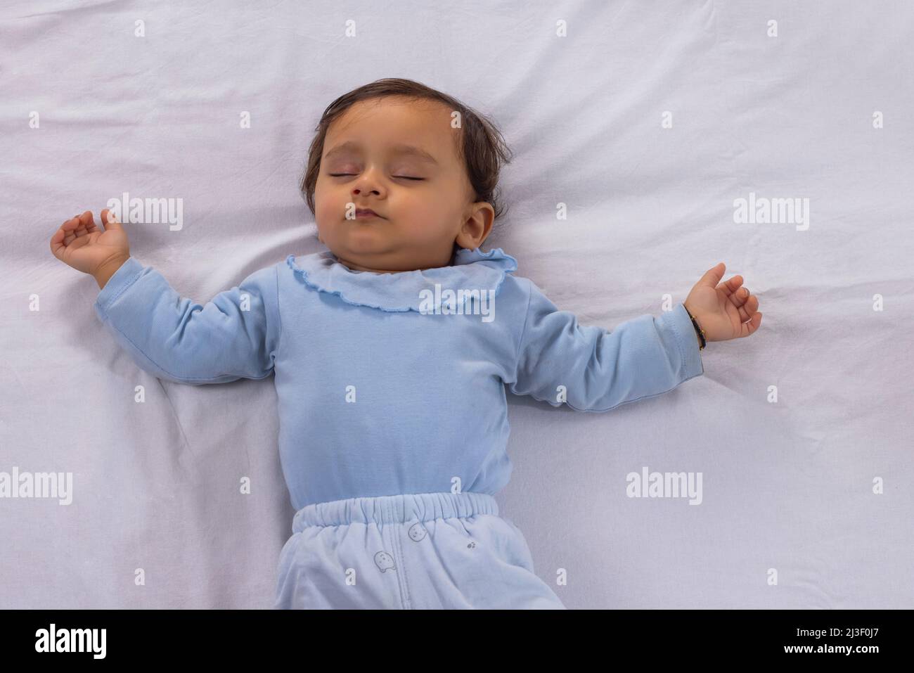 Portrait of a little baby sleeping on bed Stock Photo - Alamy