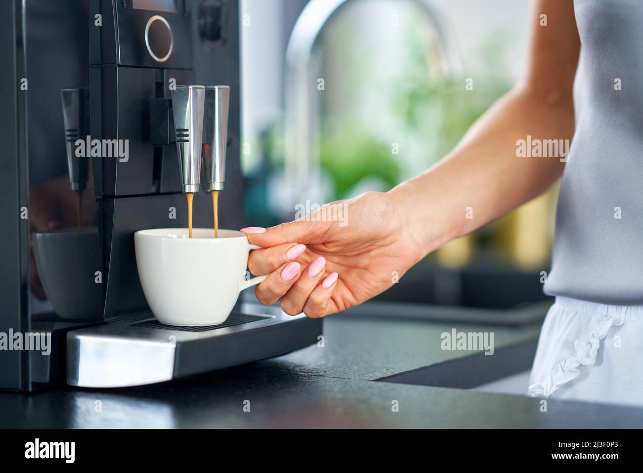 Nice woman making coffee in the kitchen Stock Photo - Alamy