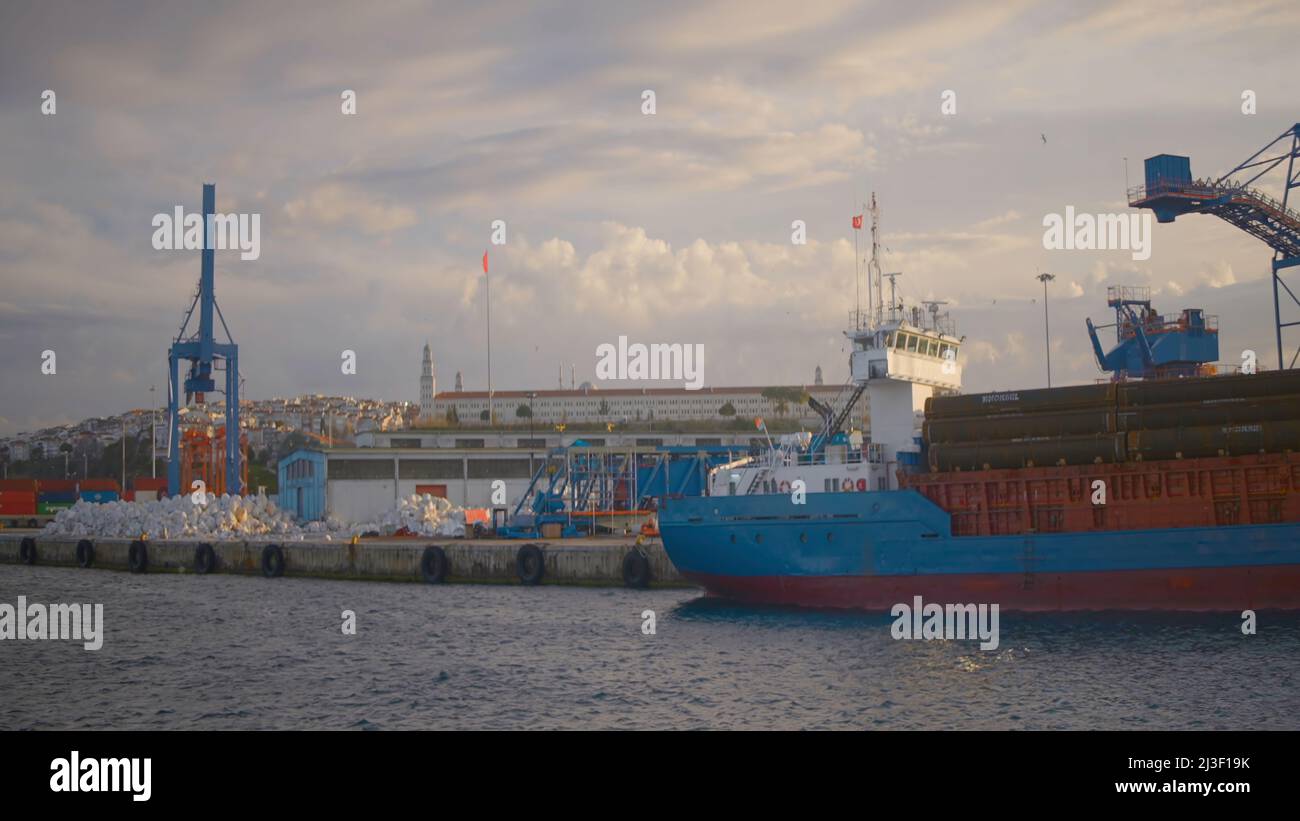 Ship at seaport on summer day. Action. Loading of goods on ships and ...