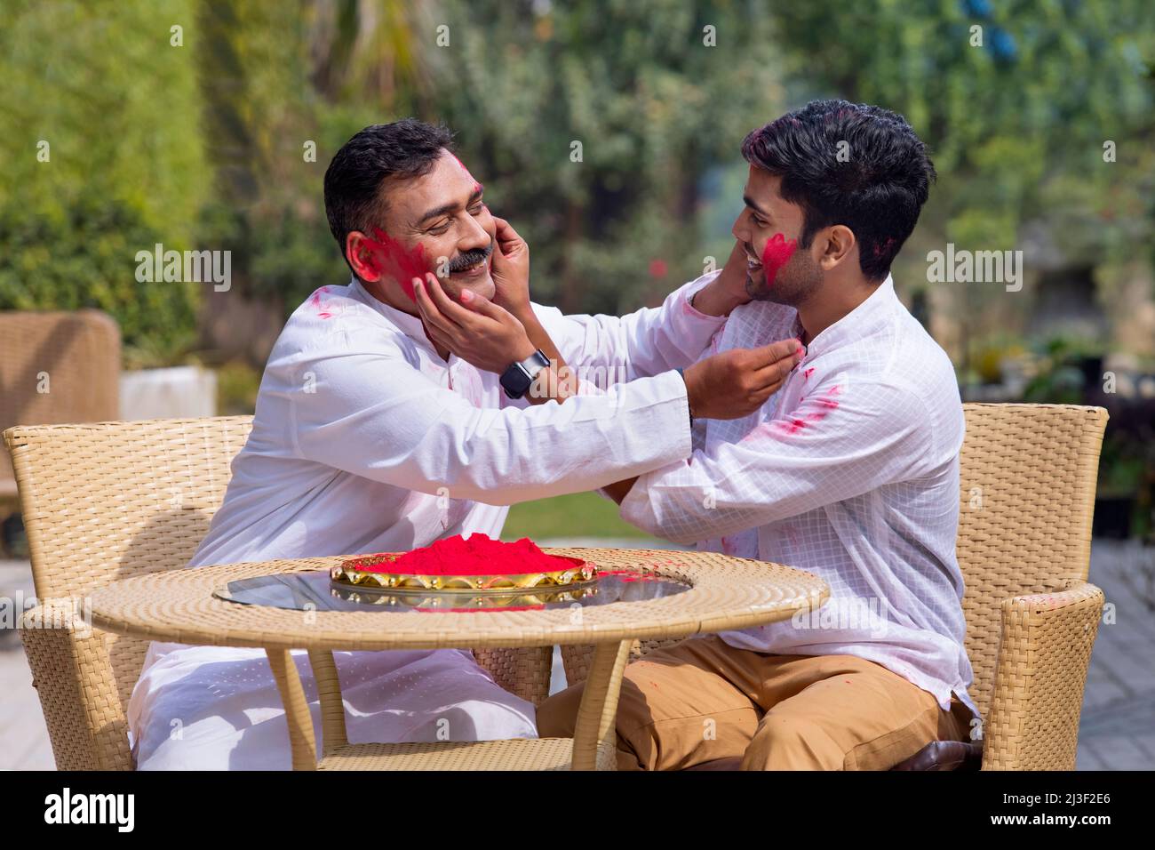 Father and Son applying dry colour to each other on the occasion of ...