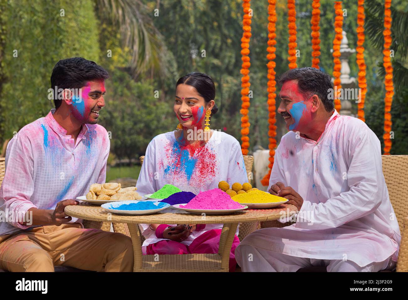 Happy Family celebrating Holi together Stock Photo - Alamy