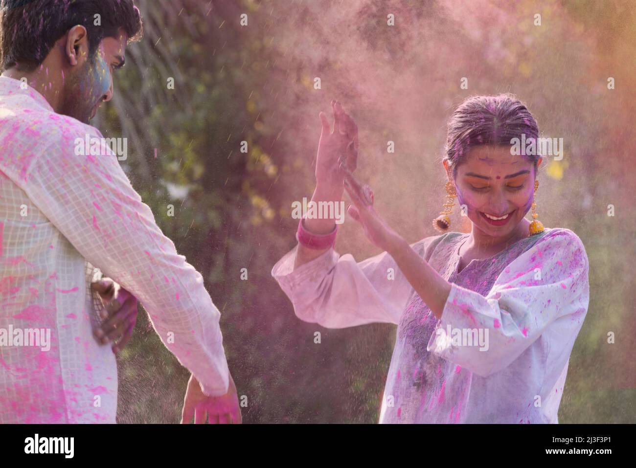 Happy couple together enjoying Holi festival with dry colours Stock ...