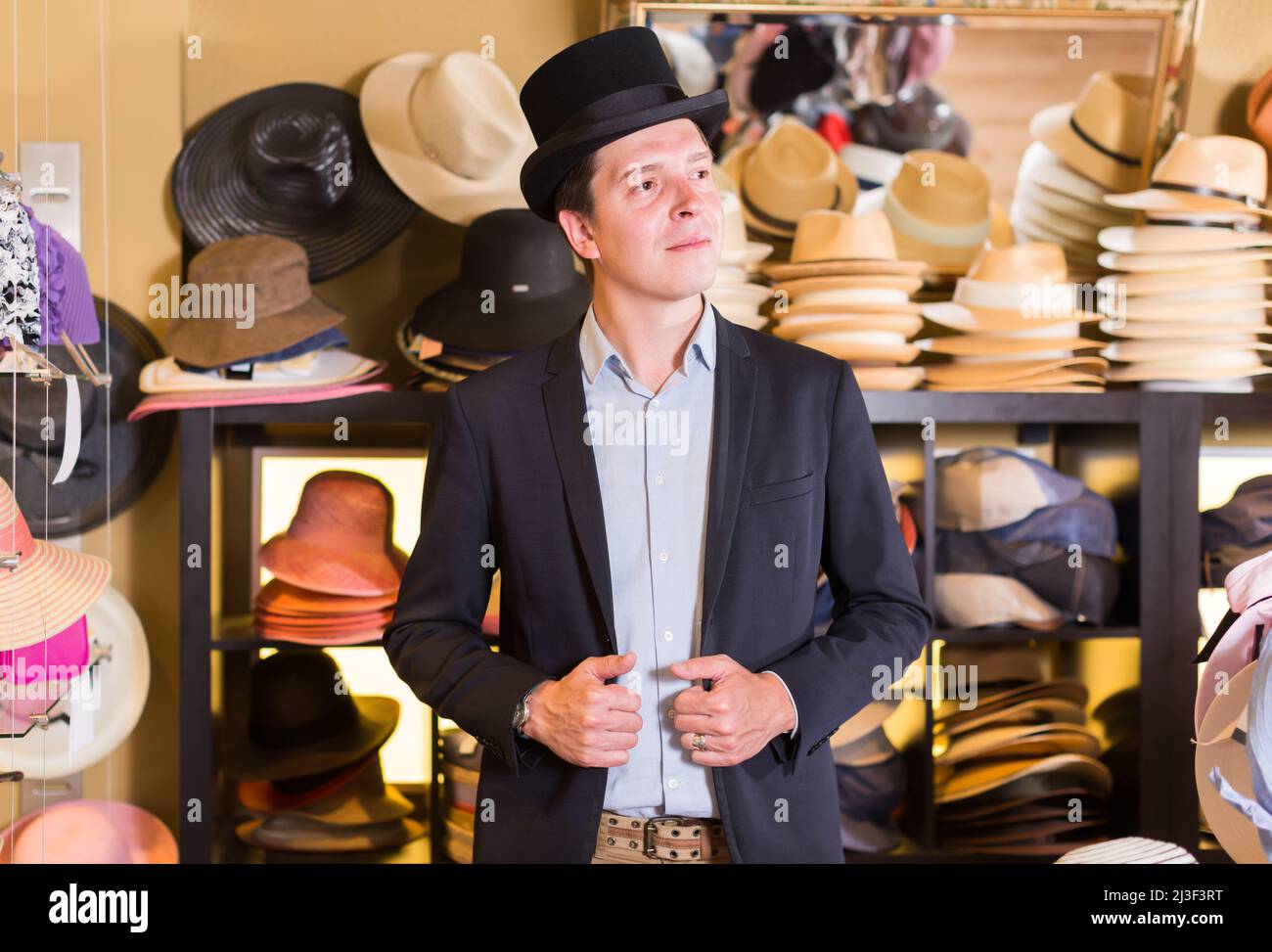 Portrait of handsome male try on hat Stock Photo - Alamy