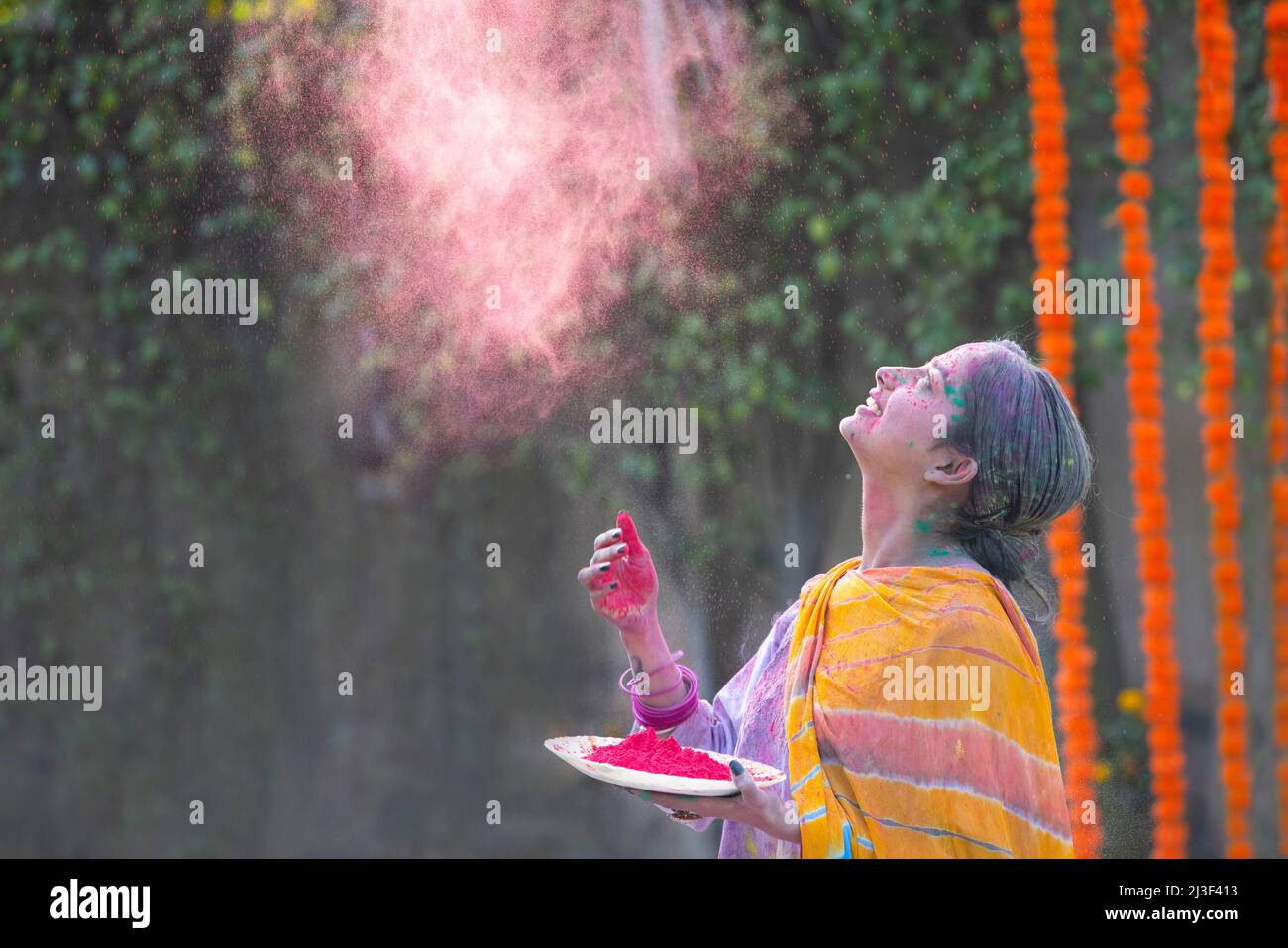 Woman holding plate holi colour hi-res stock photography and images - Alamy