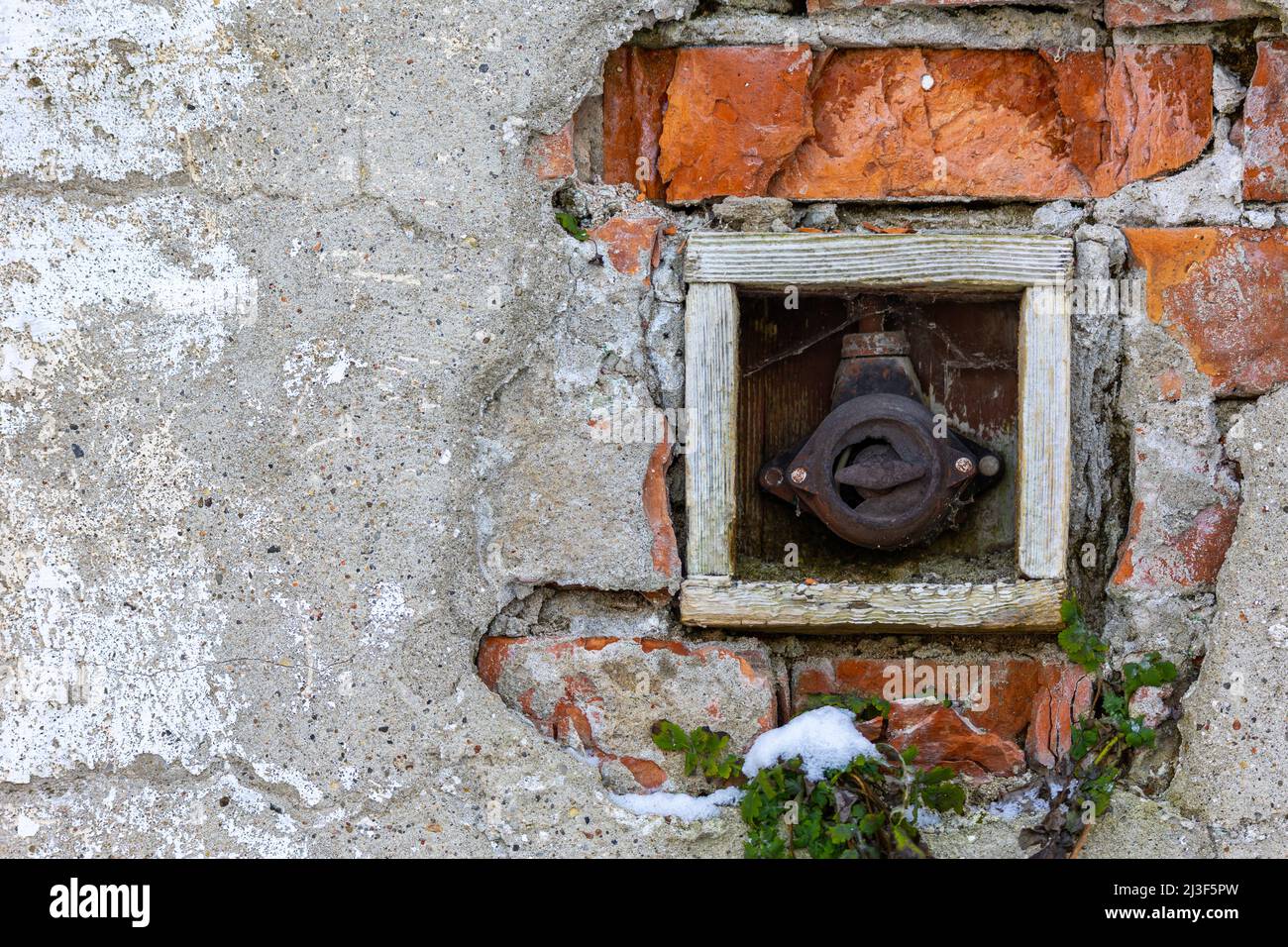 Old electrical on-off switch on the outside wall of the building ...