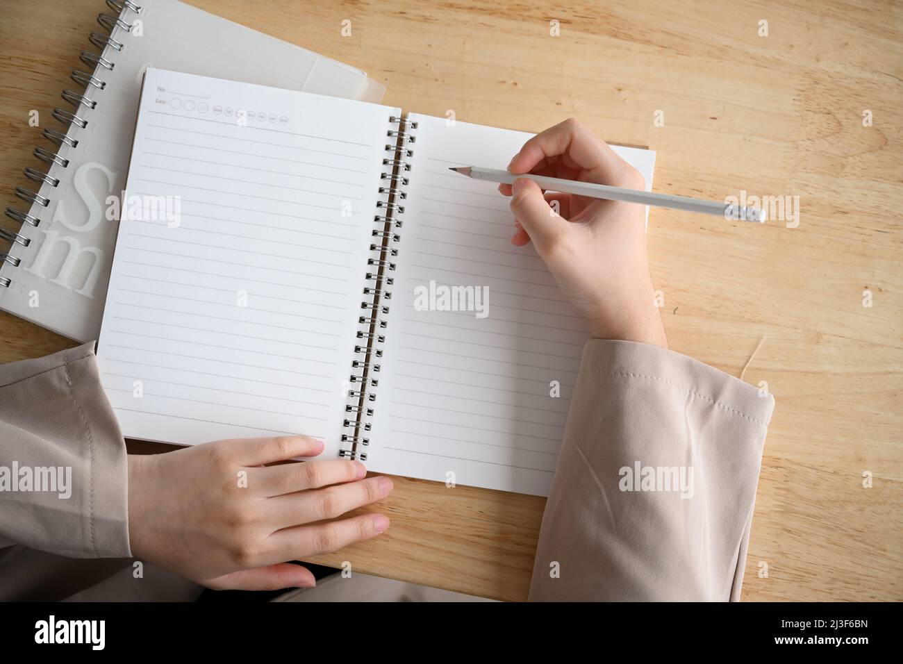Overhead shot, Female writing an essay, taking notes, doing homework ...