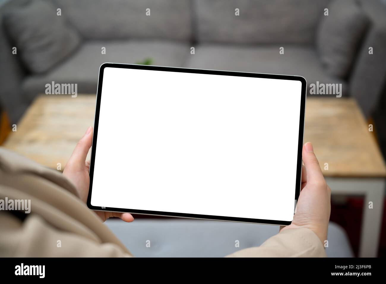 Mockup screen of a digital tablet touchpad in a woman hands over ...