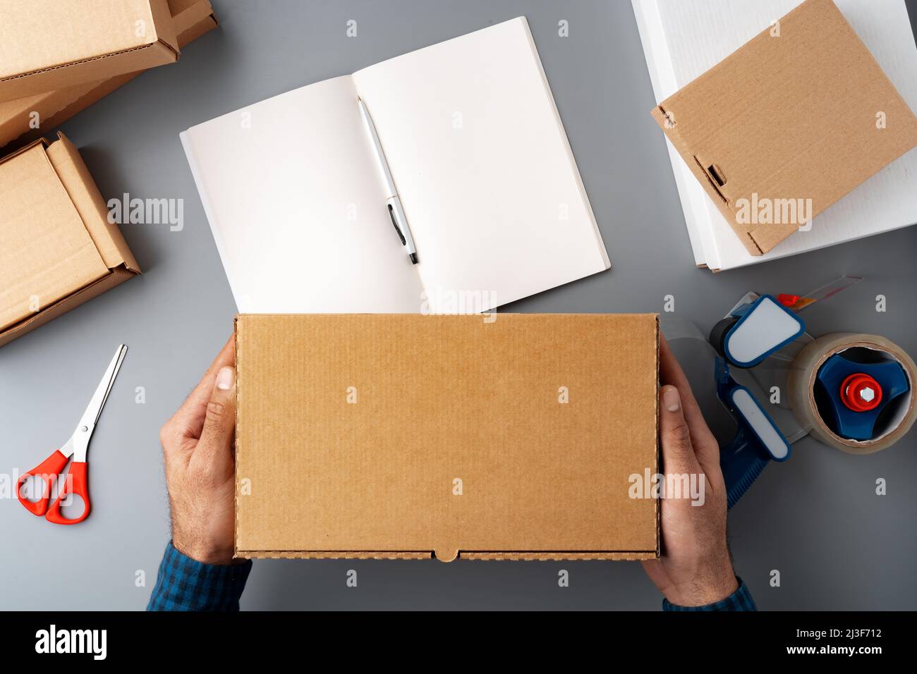 Above table top view of warehouse preparing post courier delivery ...