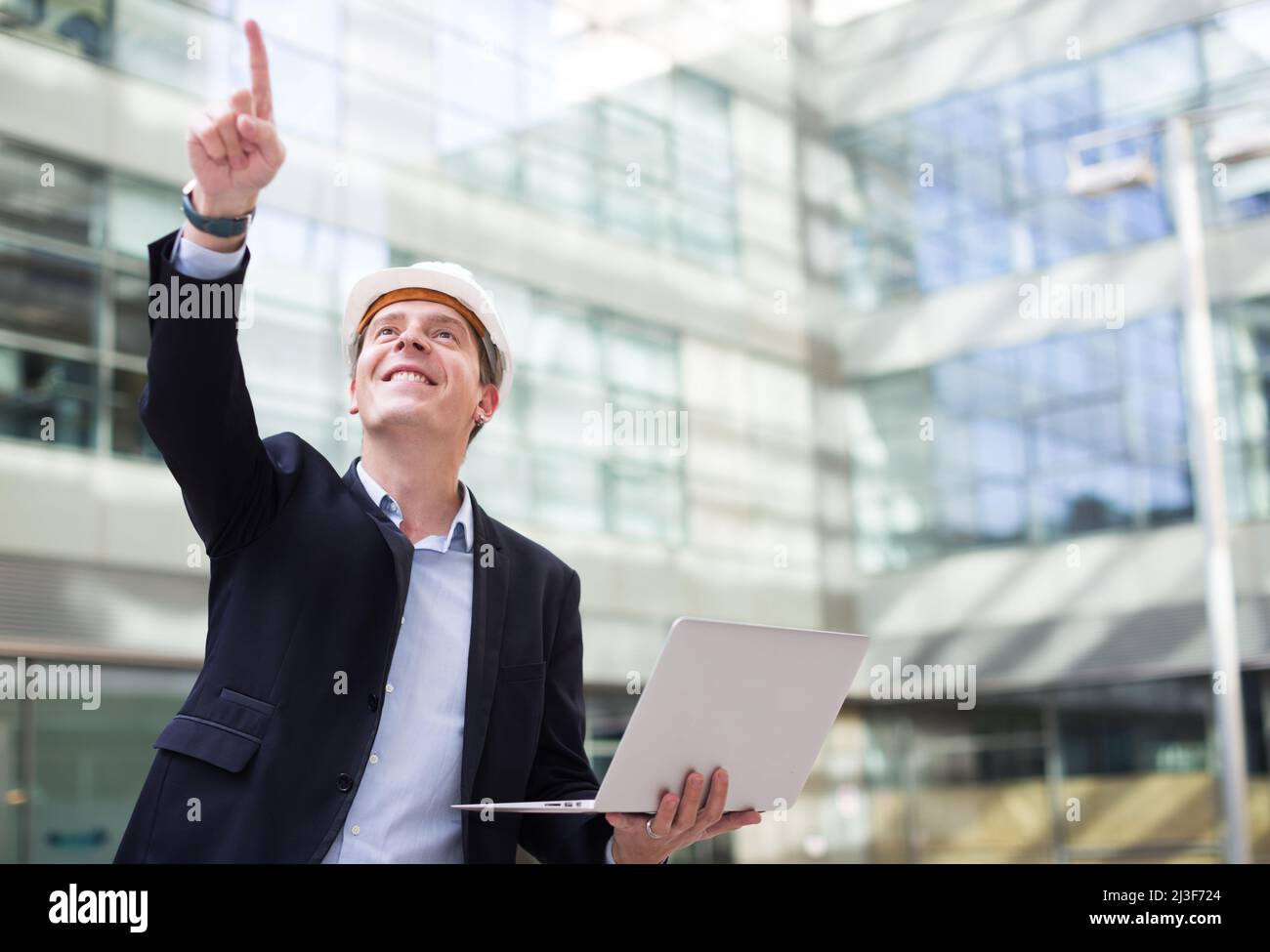 Professional worker pointing finger to object Stock Photo - Alamy