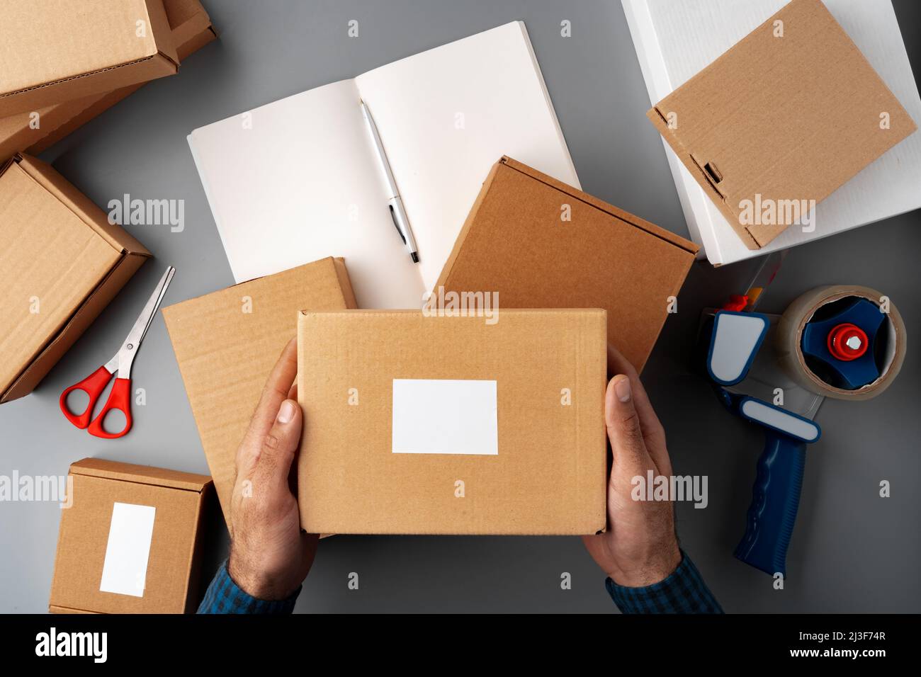 Above table top view of warehouse preparing post courier delivery ...