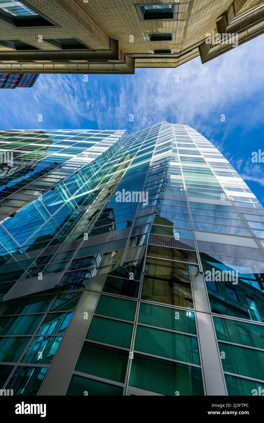 Upward view of skyscrapers with reflections in windows, London, UK ...