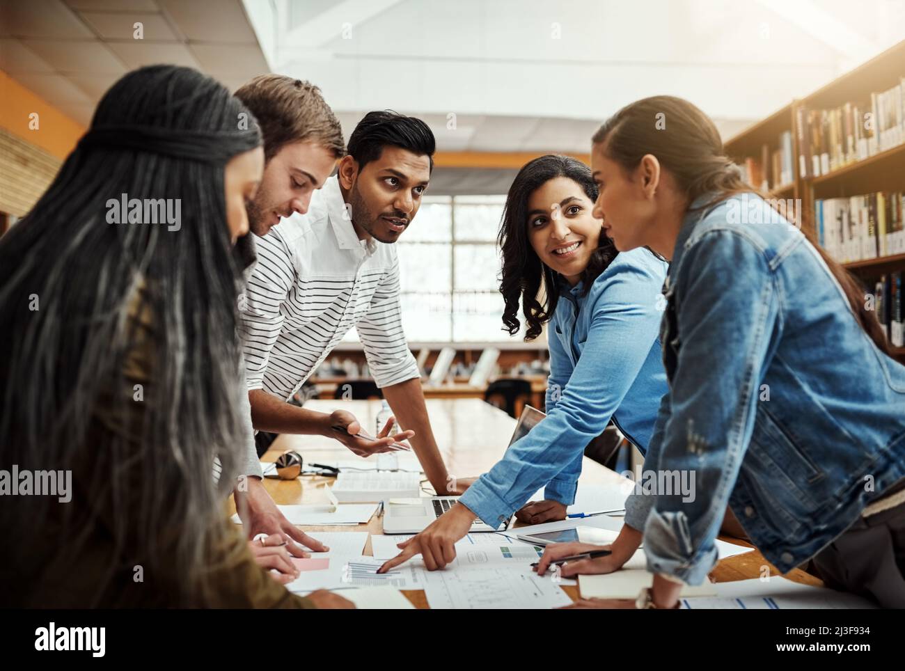 This one. Cropped shot of a group of university students studying in ...