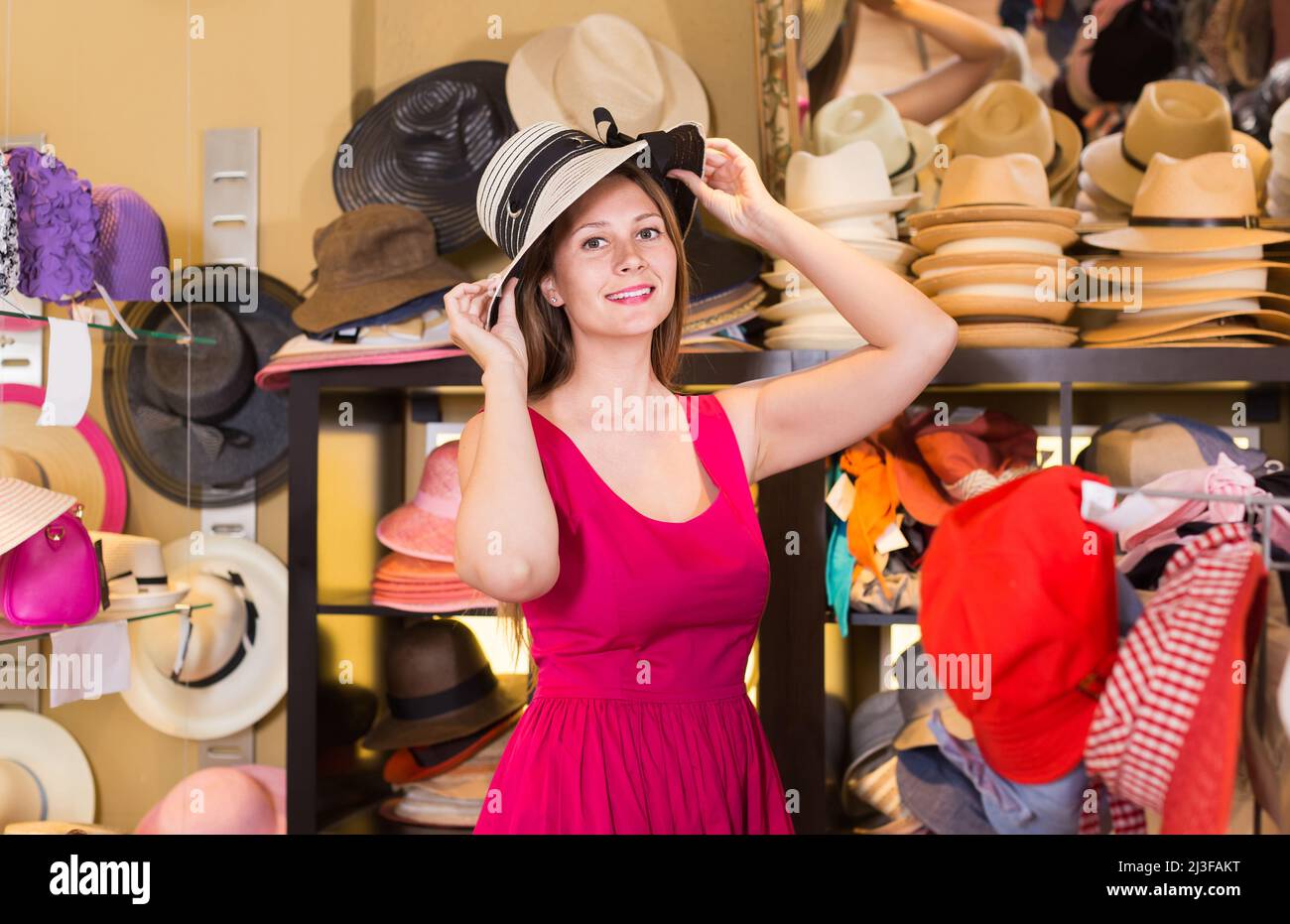 adult woman try on hatinator hat in shopping mall Stock Photo - Alamy