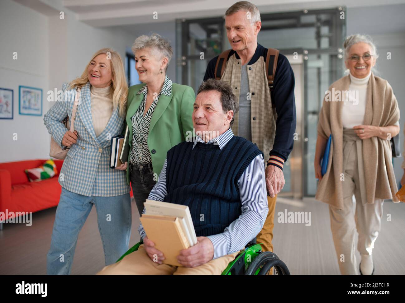 Group of happy senior students walking in corridor in university ...