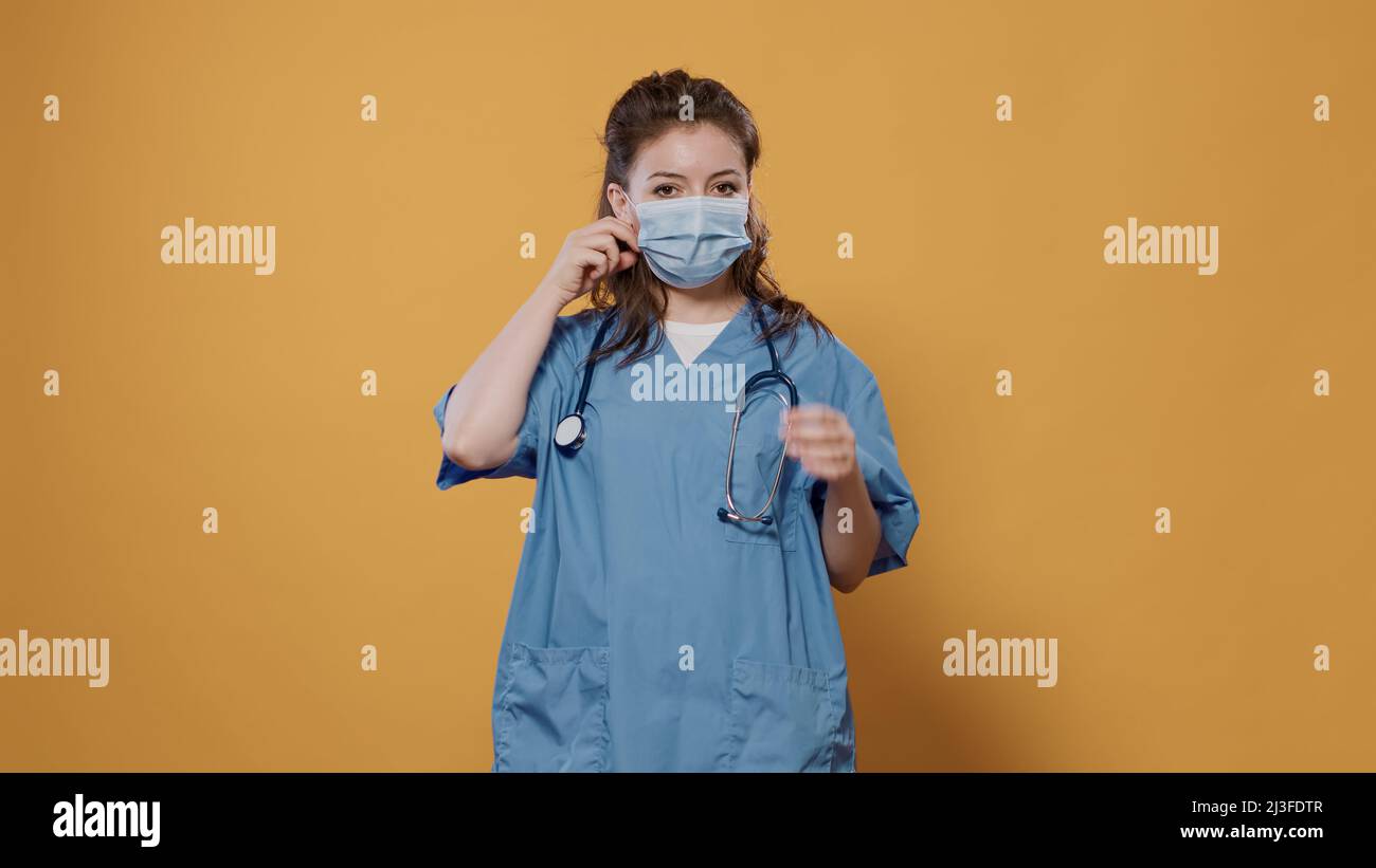 Medical doctor standing posing confident with arms crossed removing ...