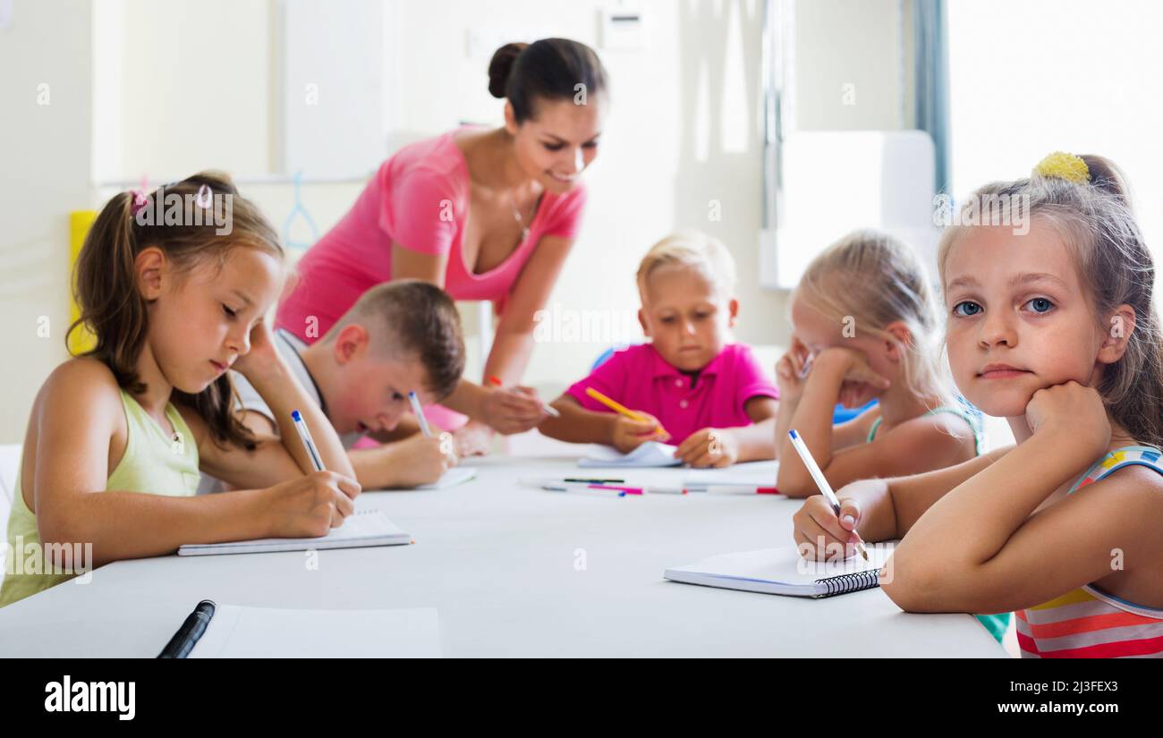 Kids learning to write on lesson in elementary school class Stock Photo ...