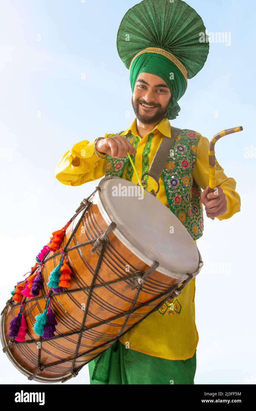Portrait of Sikh man playing drum during Baisakhi celebration Stock ...