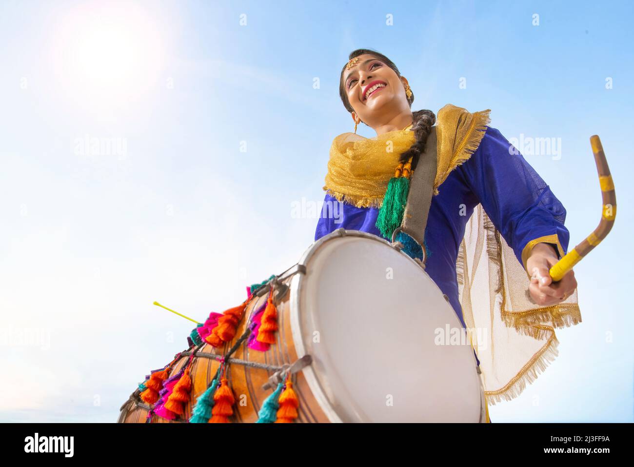 Portrait of Sikh woman playing drum during Baisakhi celebration Stock ...