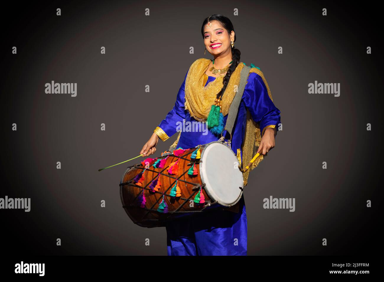 Portrait of Sikh woman playing drum during Baisakhi celebration Stock ...