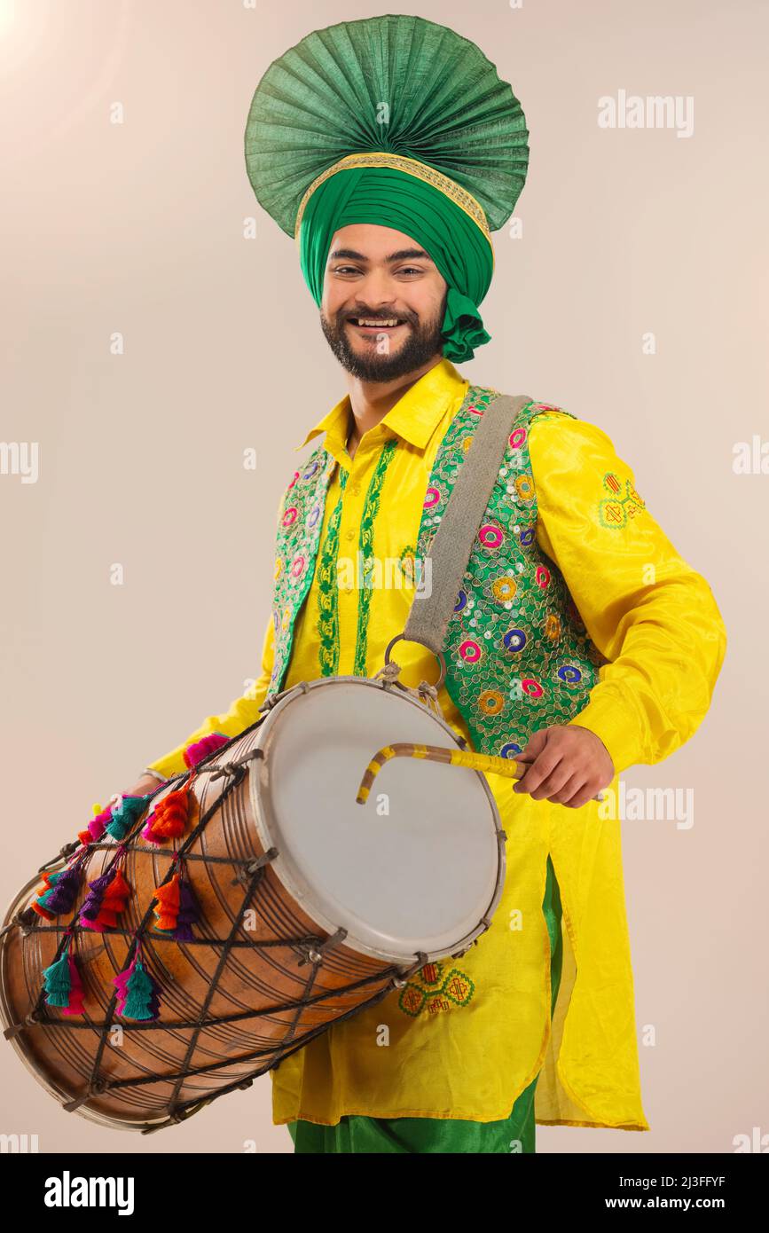 Portrait of Sikh man playing drum during Baisakhi celebration Stock ...
