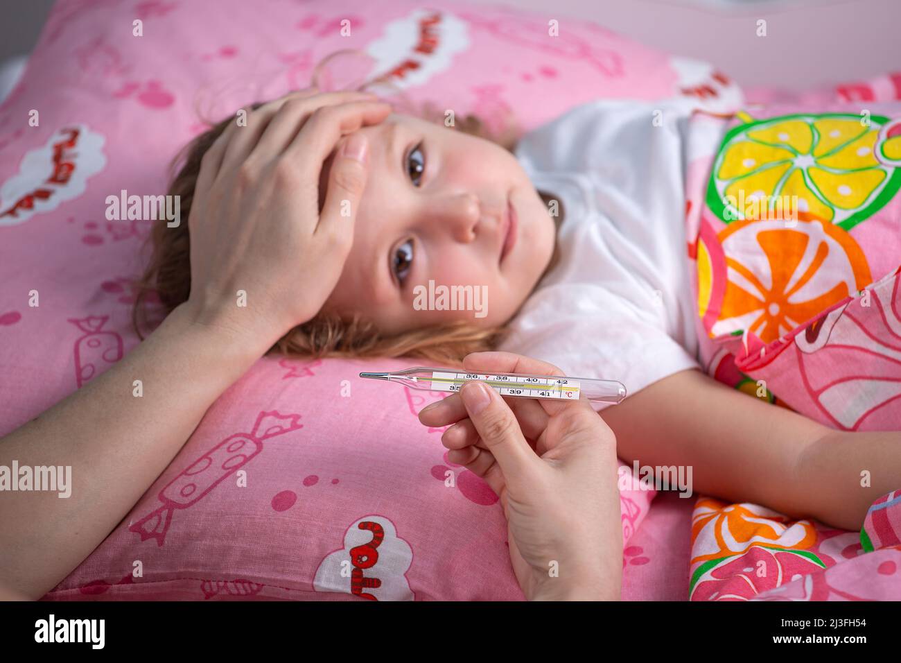 mercury thermometer with high temperature on the background of a little ...